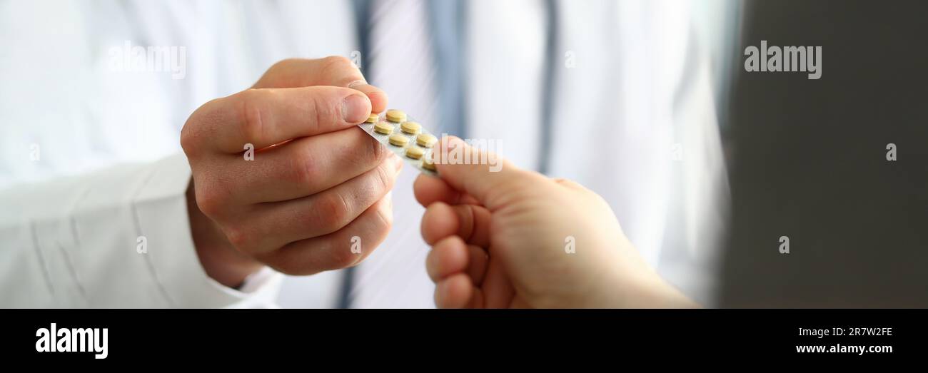 Closeup of doctor hand giving medical pills to patient. Prescribing ...