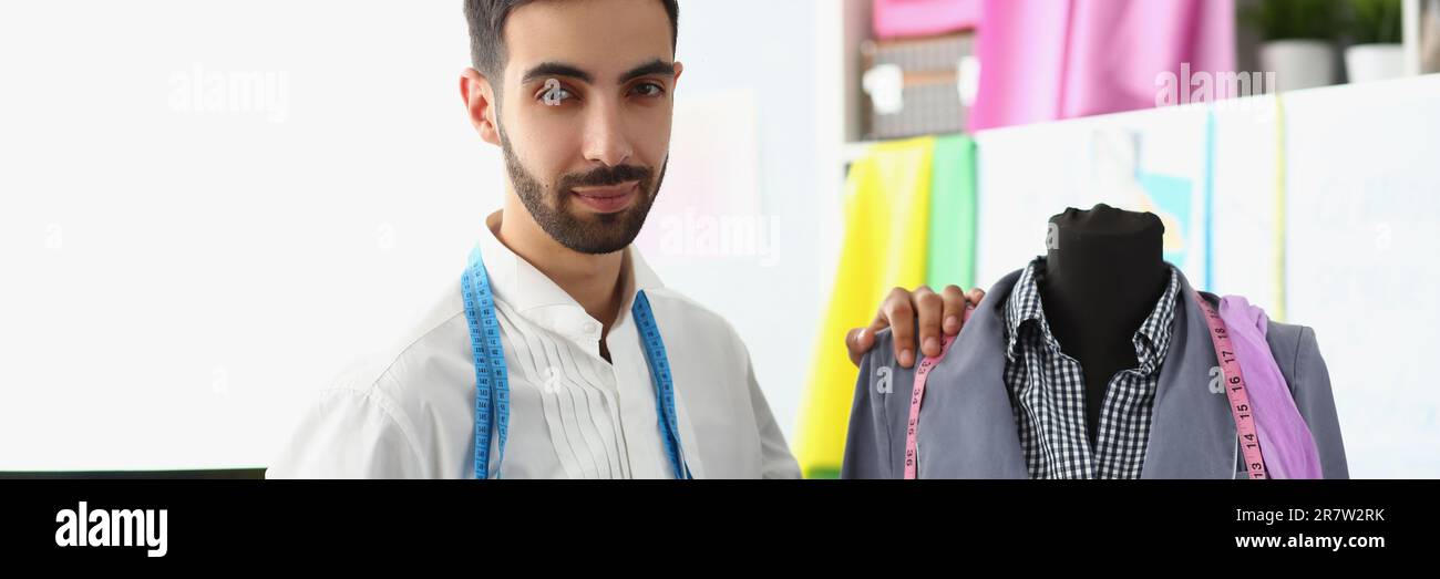Male stylist designer holding scissors next to mannequin. Creation and ...