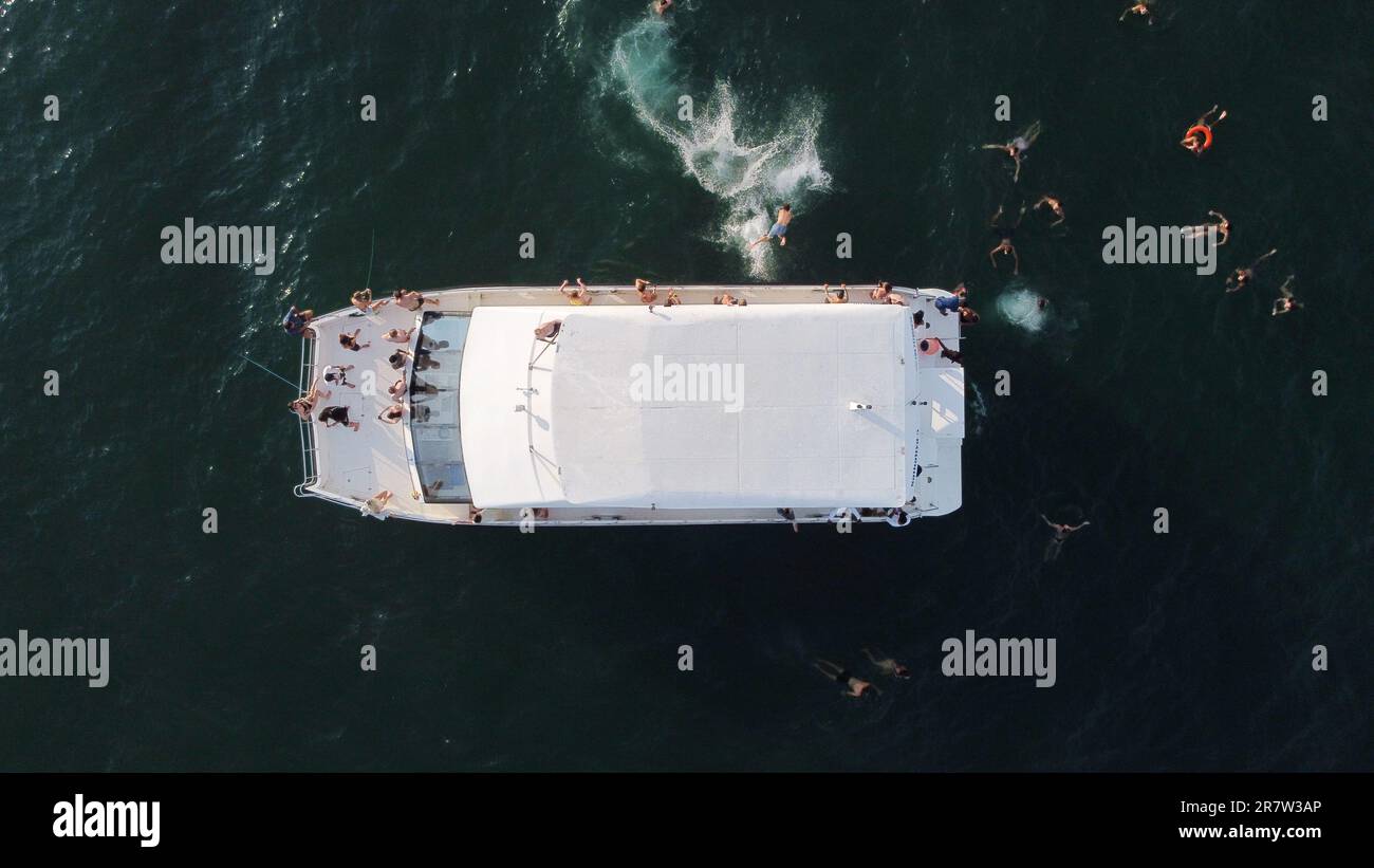 aerial view of a yacht in the ocean and floating people Stock Photo - Alamy