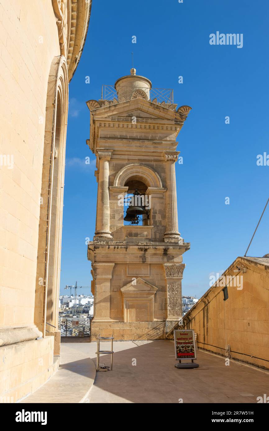 A low angle shot of the Mosta Rotunda under a blue sky and sunlight in ...