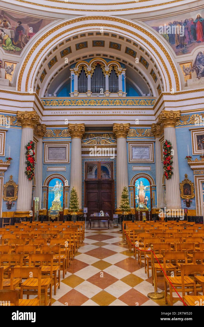 The interior of the Mosta Rotunda decorated with religious icons in ...