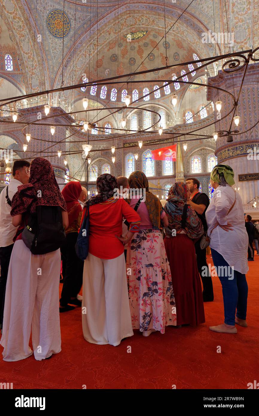 Colourful tour group inside the Blue Mosque aka Sultan Ahmed Mosque ...