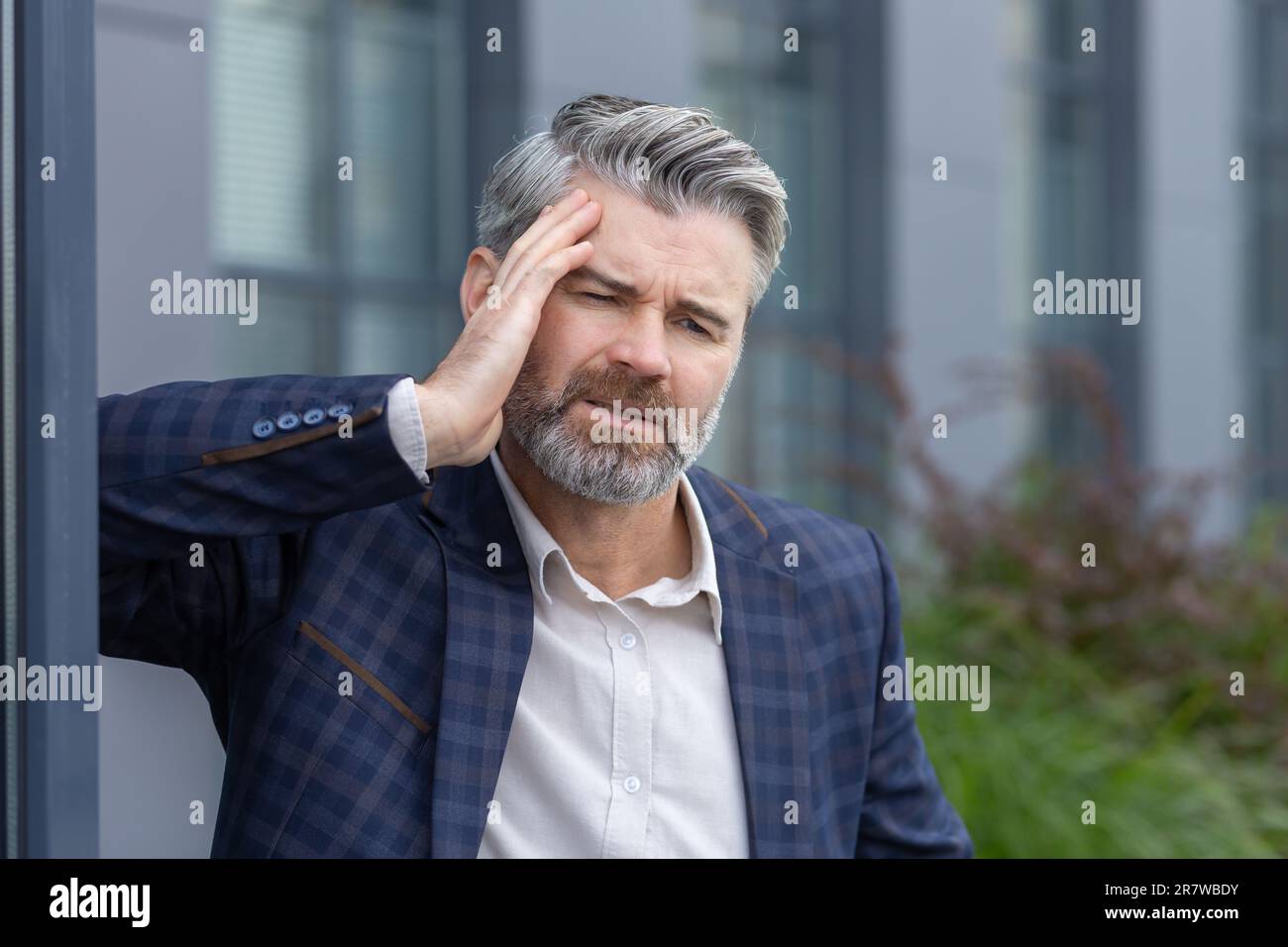 Mature boss sick, man has severe headache, businessman in business suit ...