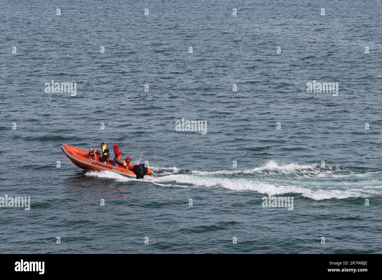 An Inflatable lifeguard boat patrols the sea off the coast of Brighton ...