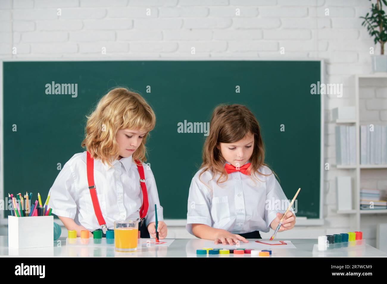 Portrait school kids doing art homework. Children drawing on elementary ...