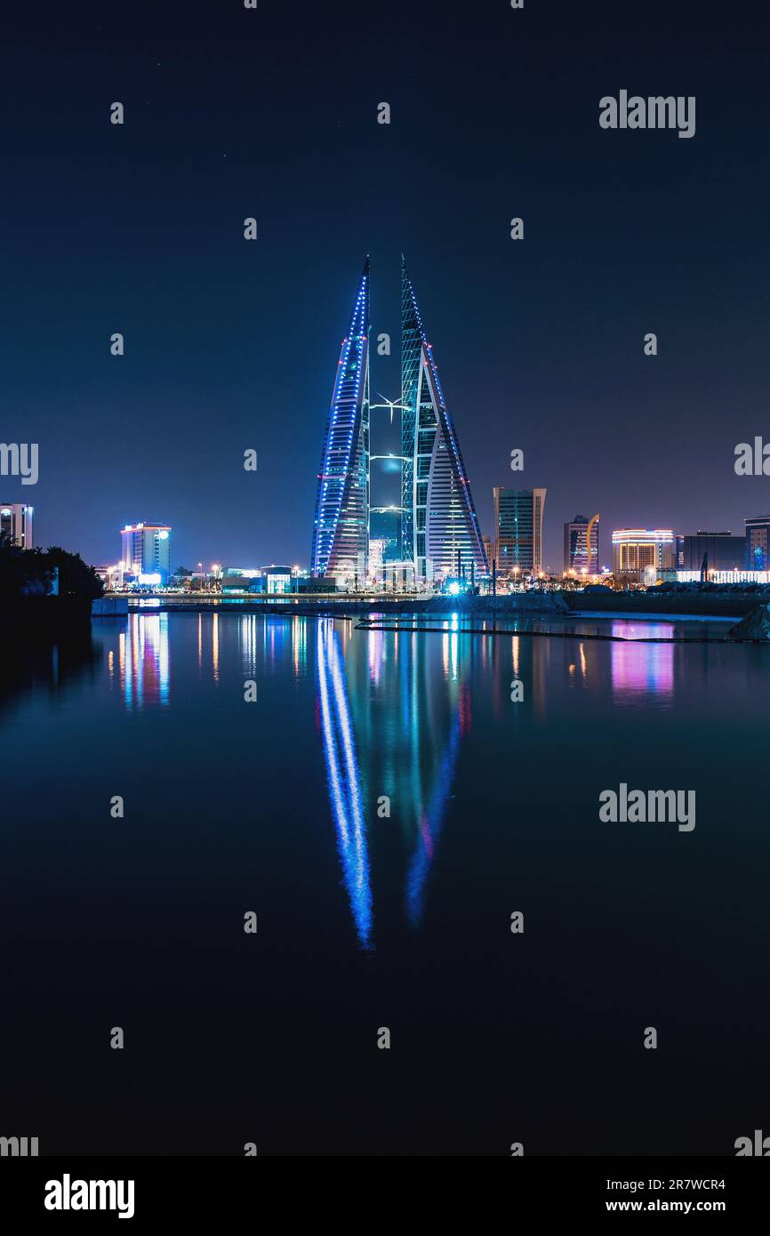 A tranquil urban landscape featuring a canal lit up by the night sky ...