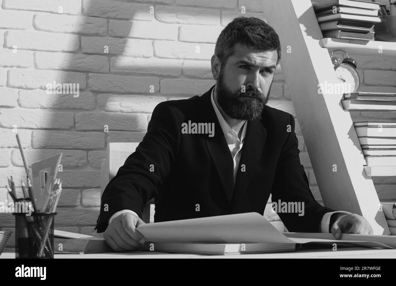 Portrait of serious teacher in school classroom. Tutor, professor ...