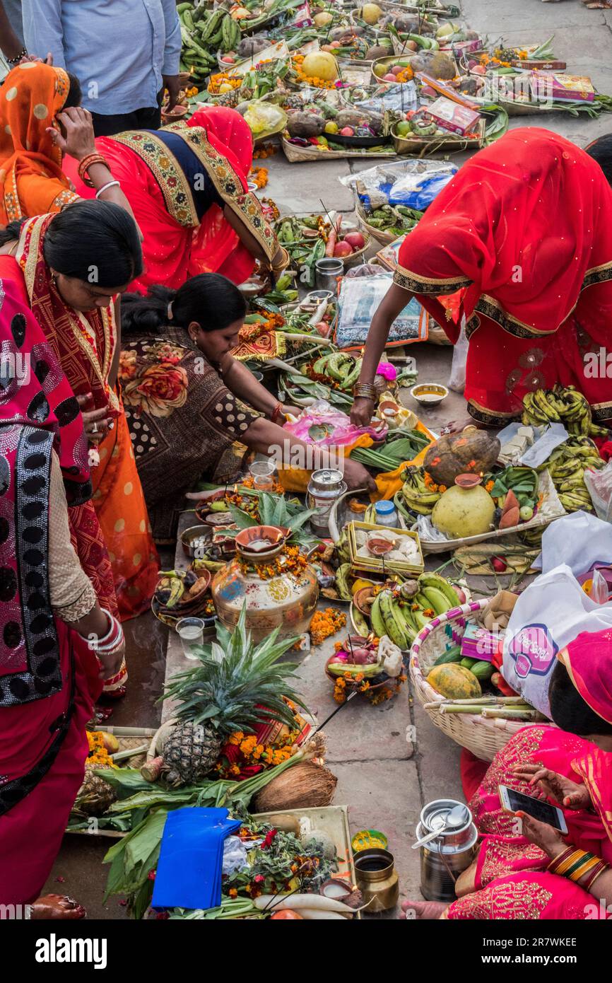Devotees make offerings and pray in the Ganges during Chhath Puja in ...