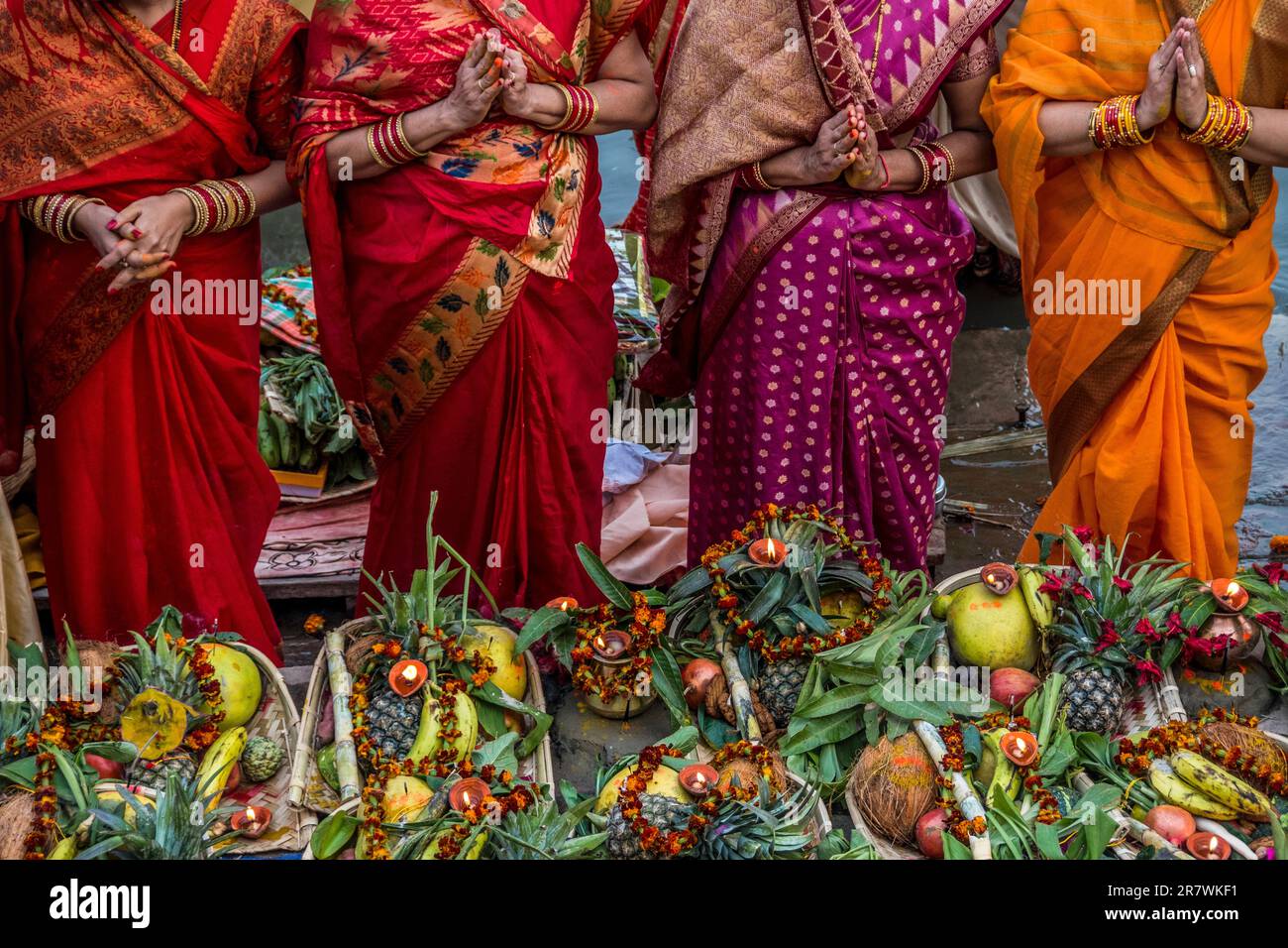 Devotees make offerings and pray in the Ganges during Chhath Puja in ...