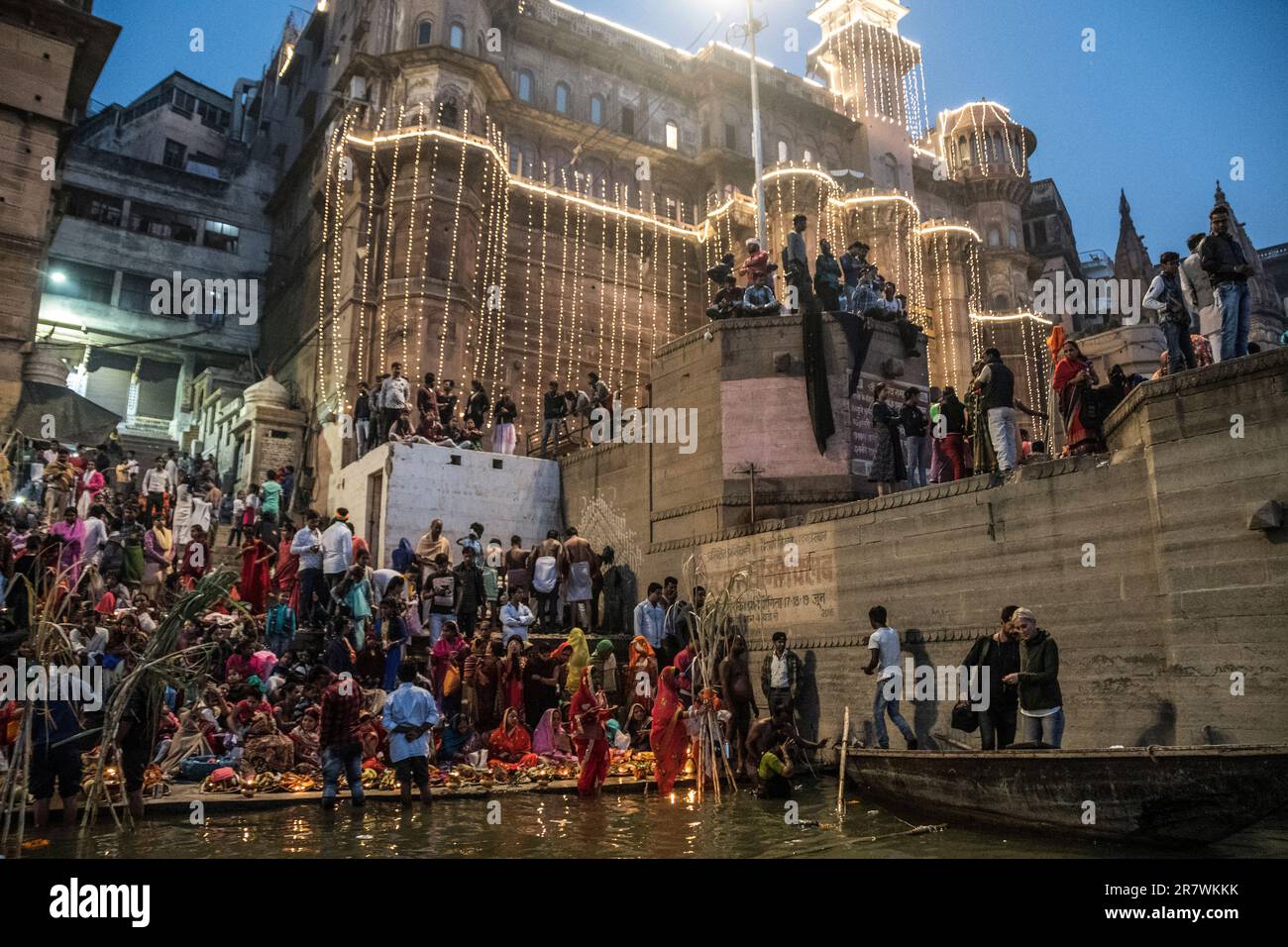 Devotees make offerings and pray in the Ganges during Chhath Puja in Varanasi, India Stock Photo ...