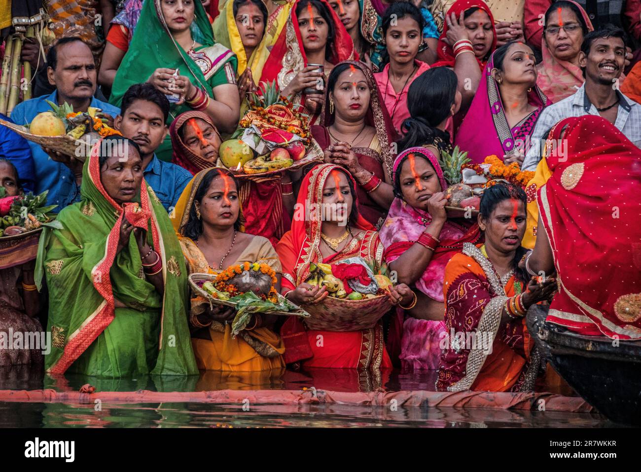 Devotees make offerings and pray in the Ganges during Chhath Puja in ...