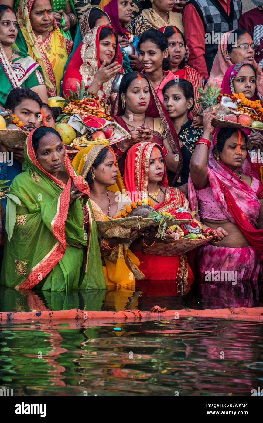Devotees make offerings and pray in the Ganges during Chhath Puja in ...