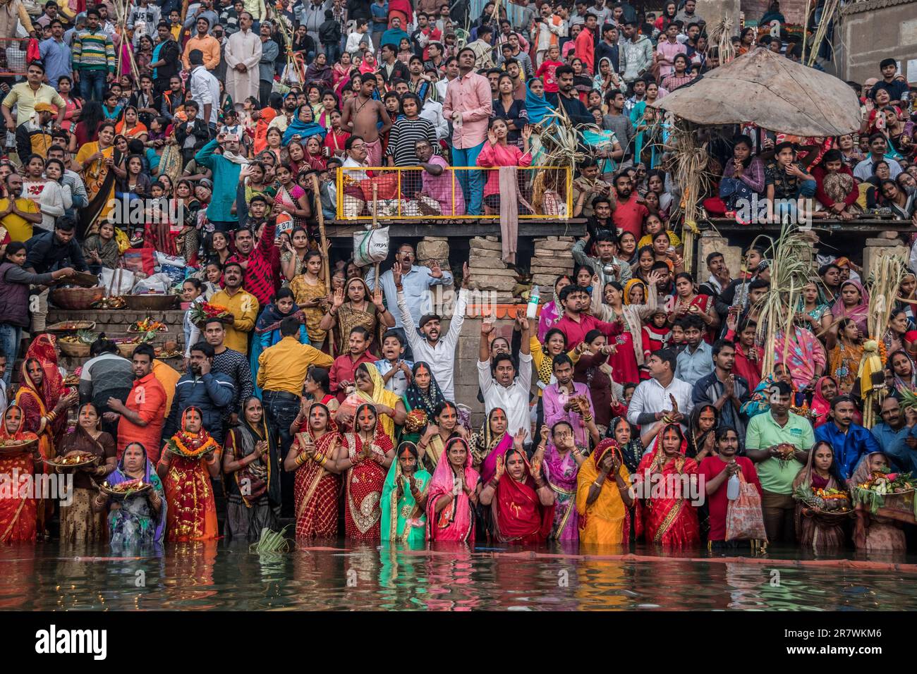 Devotees make offerings and pray in the Ganges during Chhath Puja in Varanasi, India Stock Photo ...