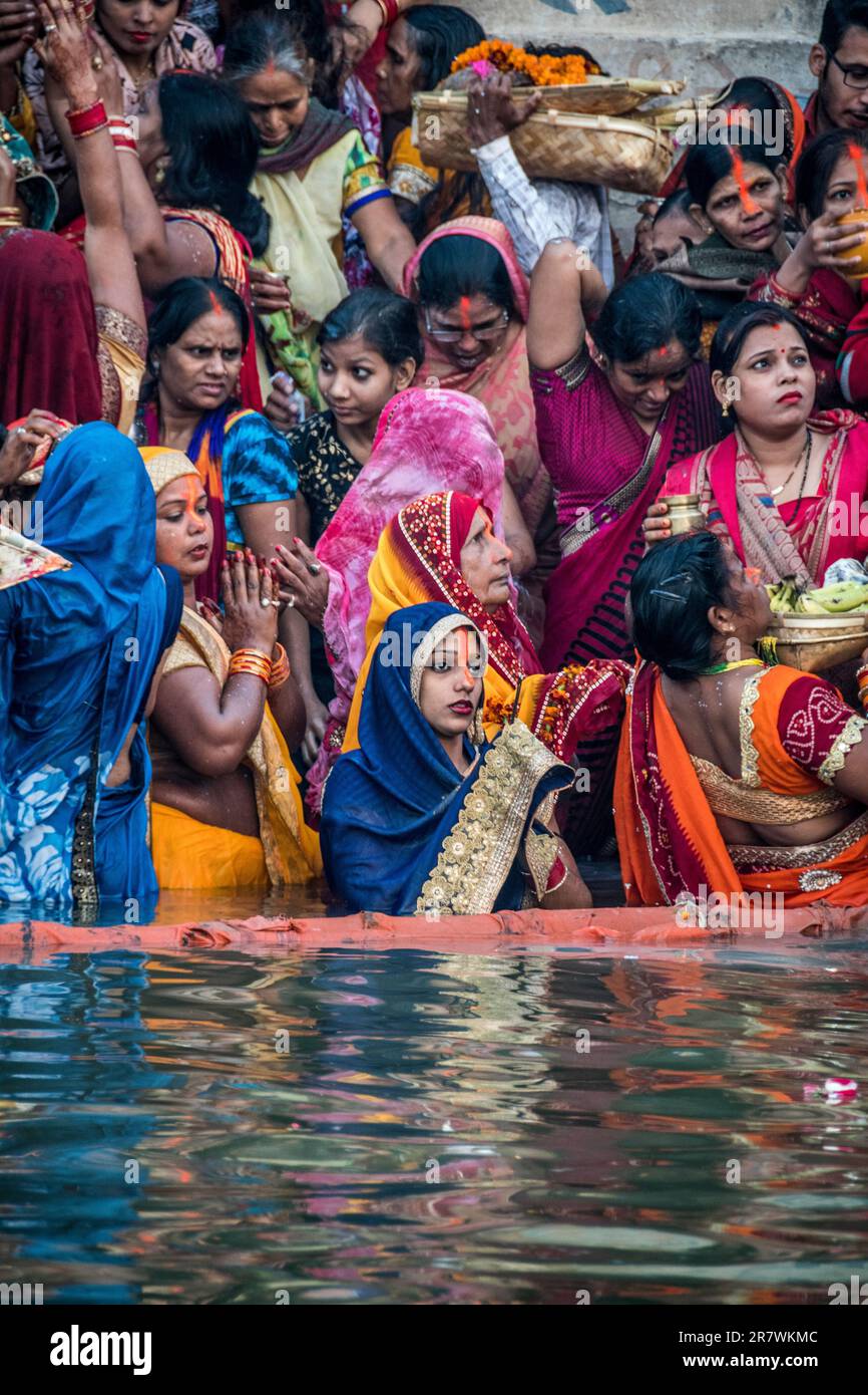 Devotees make offerings and pray in the Ganges during Chhath Puja in Varanasi, India Stock Photo ...