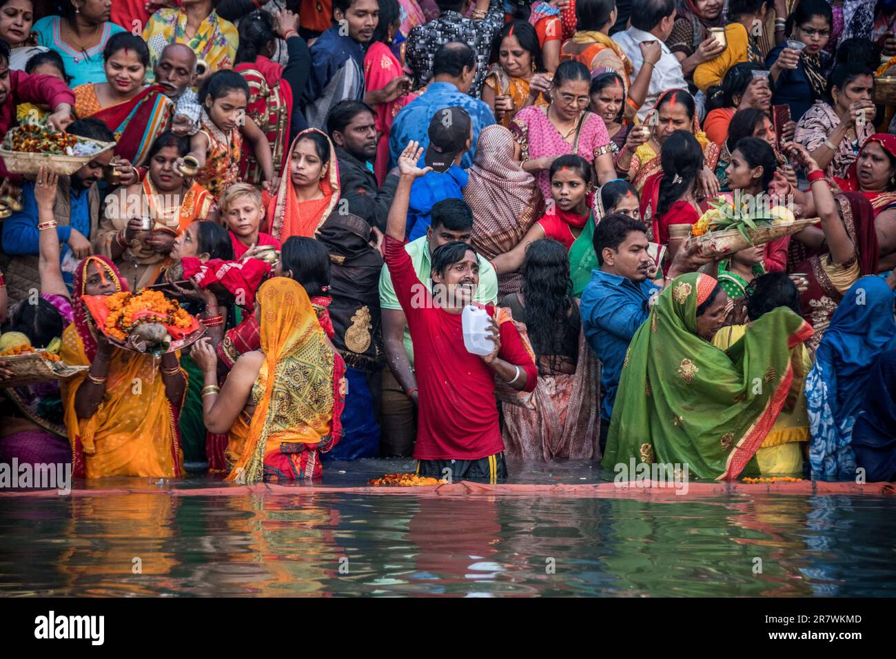 Devotees make offerings and pray in the Ganges during Chhath Puja in Varanasi, India Stock Photo ...