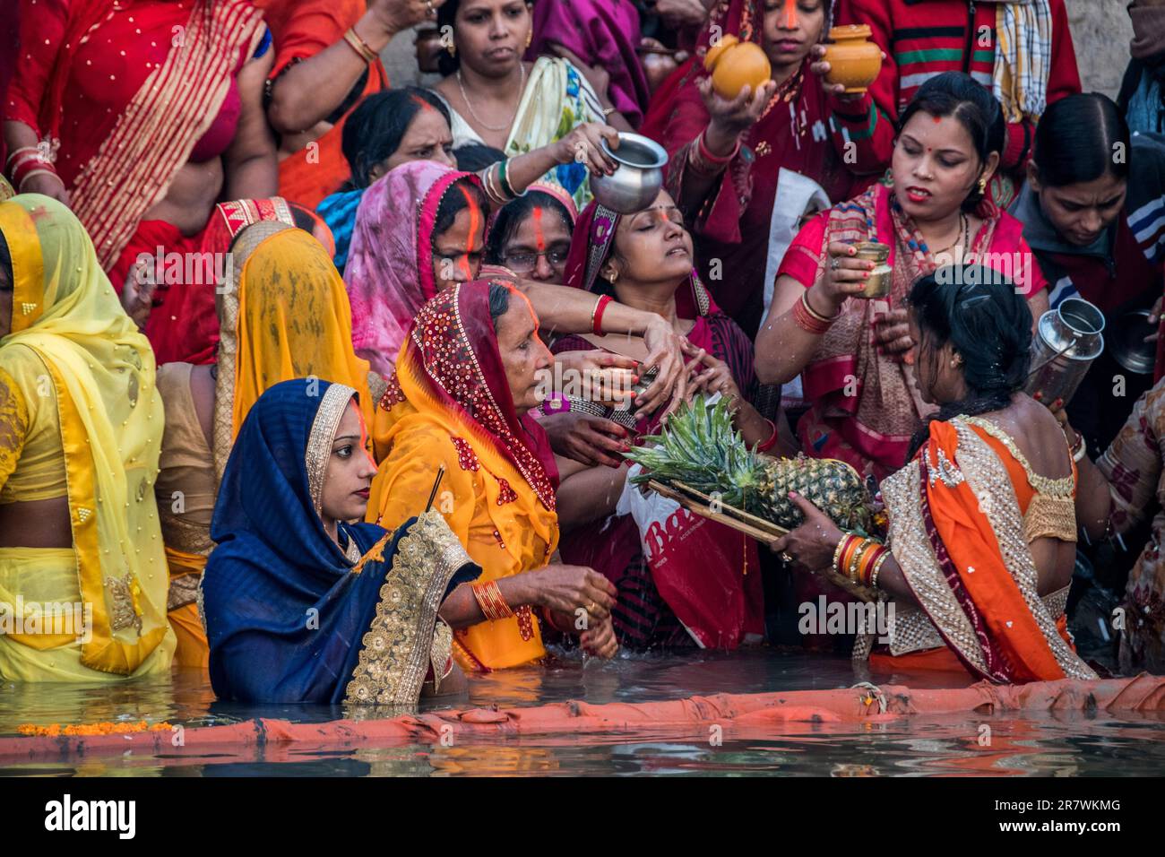 Devotees make offerings and pray in the Ganges during Chhath Puja in Varanasi, India Stock Photo ...