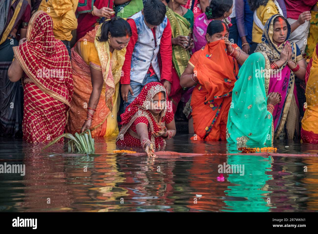Devotees make offerings and pray in the Ganges during Chhath Puja in ...