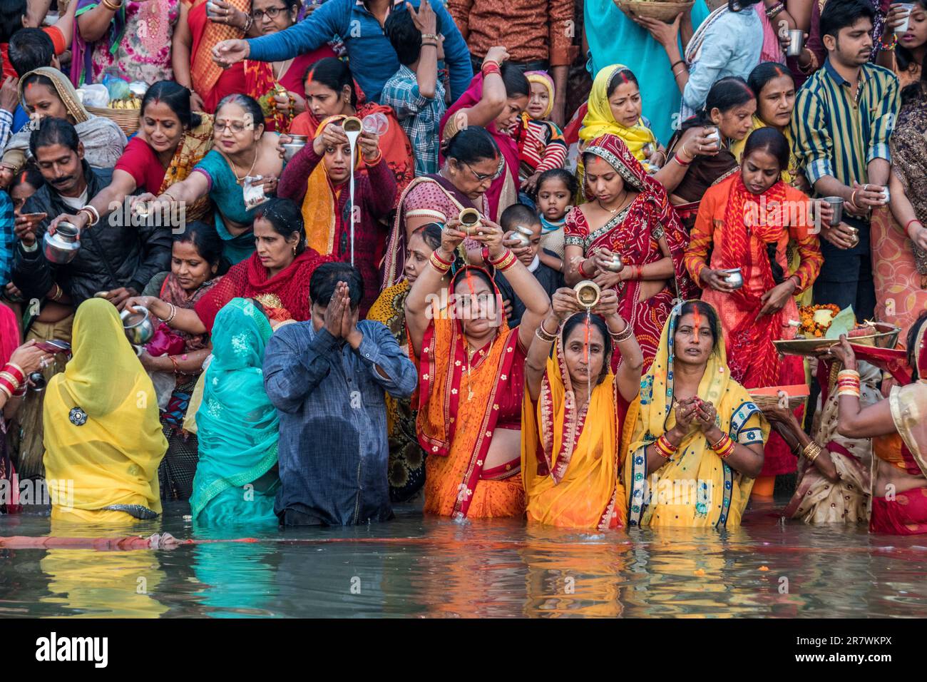Devotees make offerings and pray in the Ganges during Chhath Puja in ...