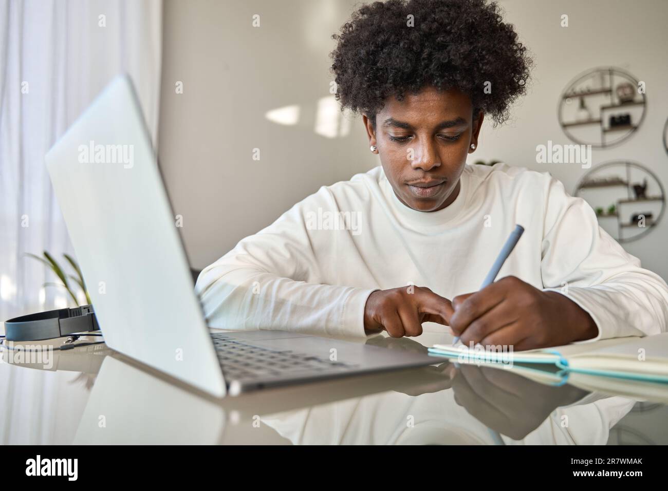 African American student elearning virtual study class, writing notes ...