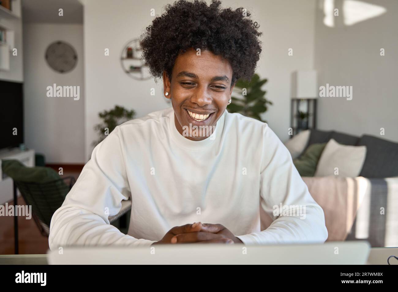 Happy African gen z teen student hybrid elearning, watching webinar at ...