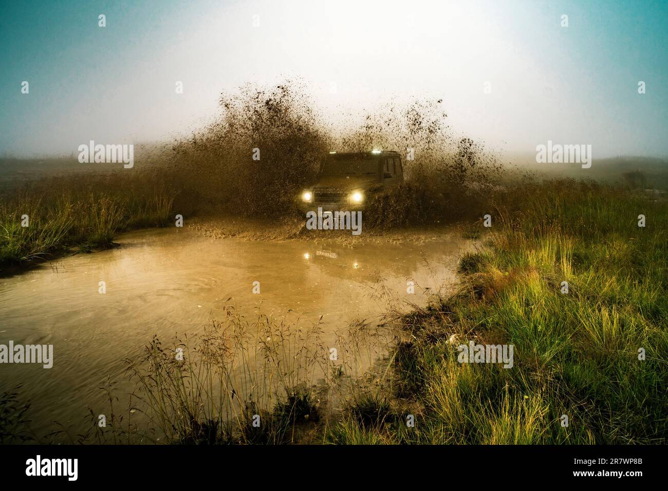 SUV race on dirt. Off road vehicle coming out of a mud hole hazard ...