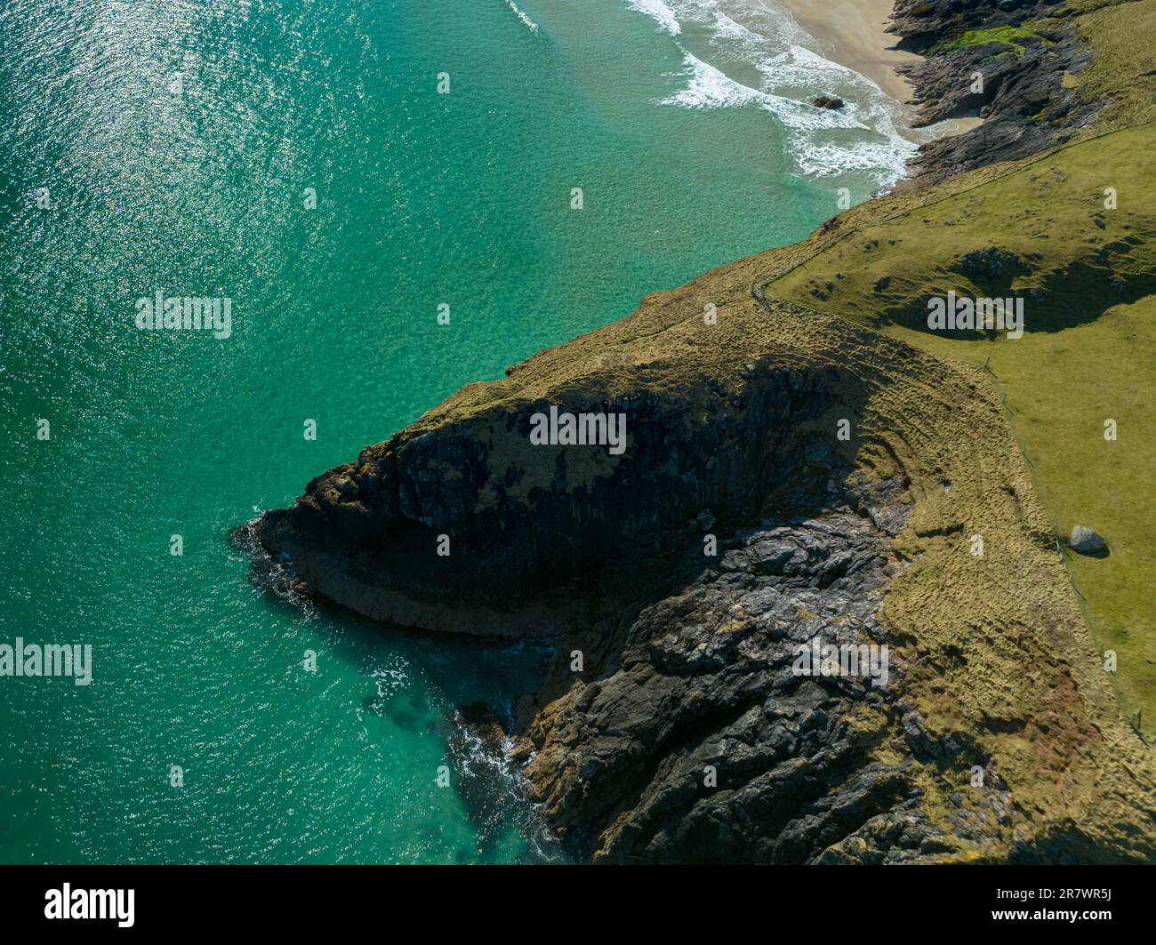 An aerial view of a crystalclear ocean surrounding a picturesque ...