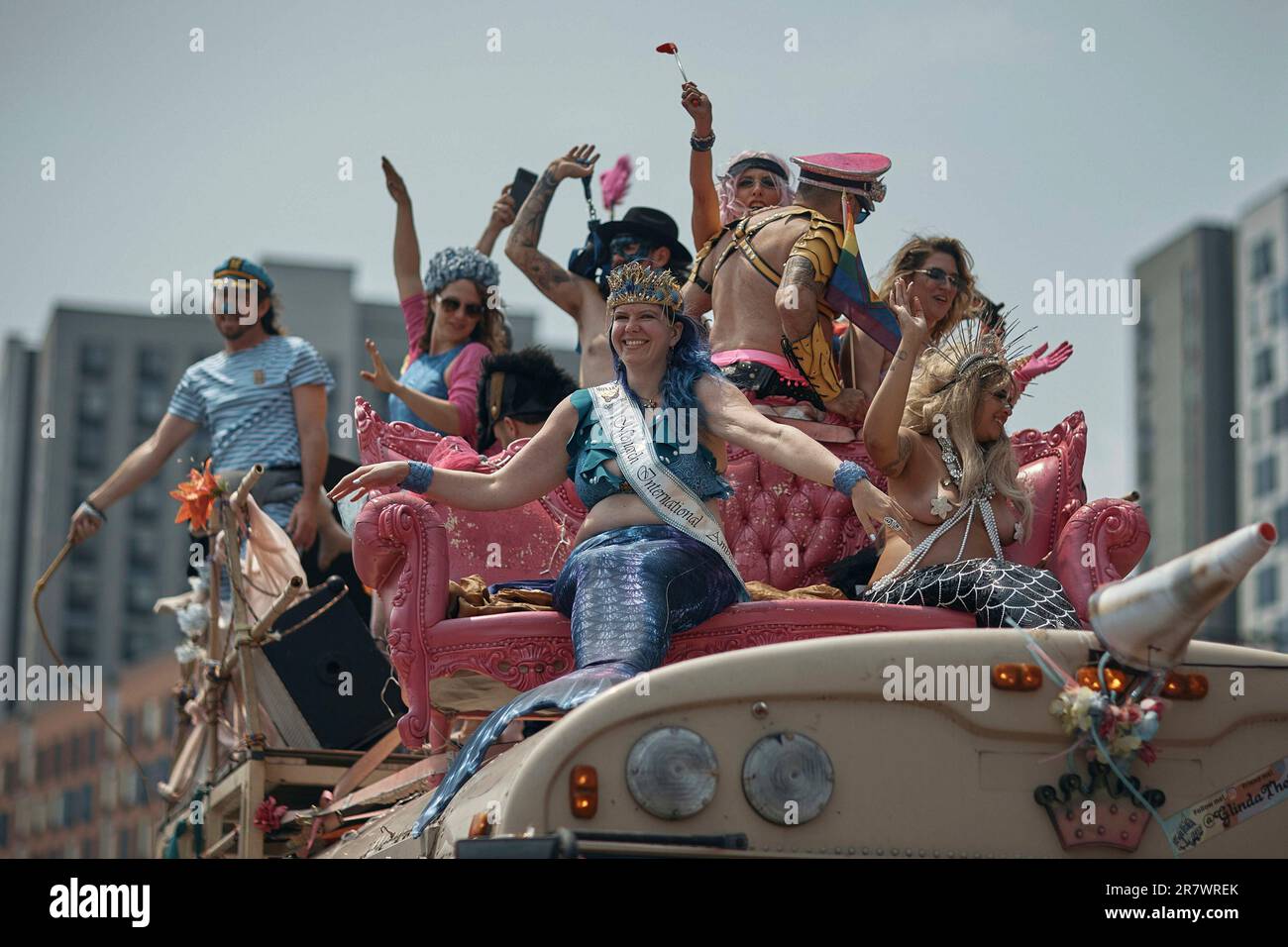 Revelers salute from a float during the Mermaid Parade in the Coney ...