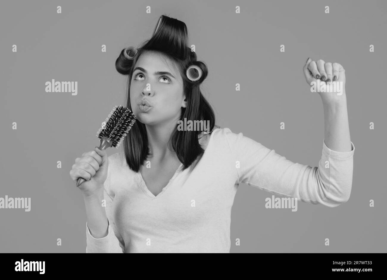 Funny woman singing with comb. Brushing Hair. Portrait young woman ...