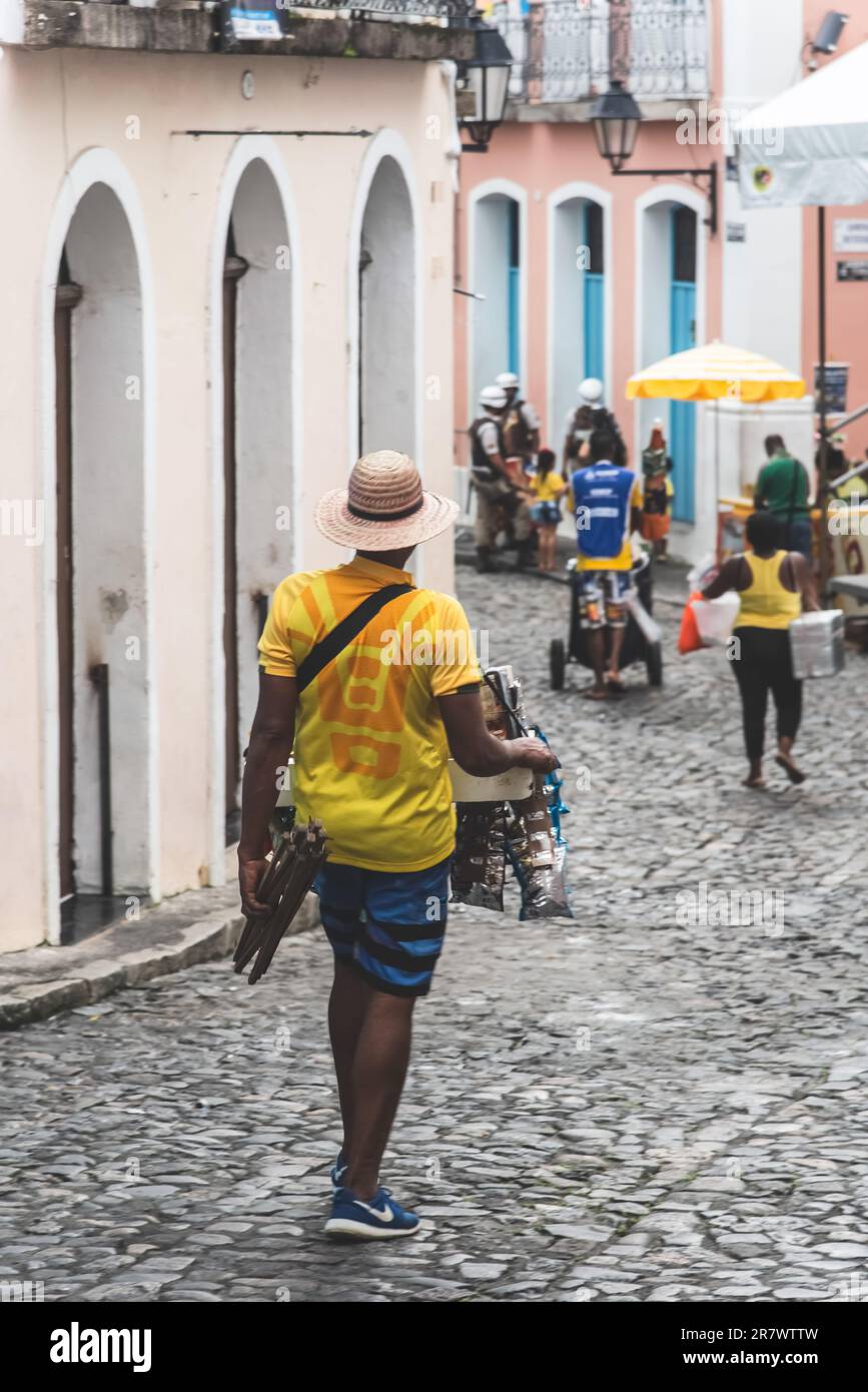 A worker walking down a picturesque cobblestone street in Brazil Stock ...