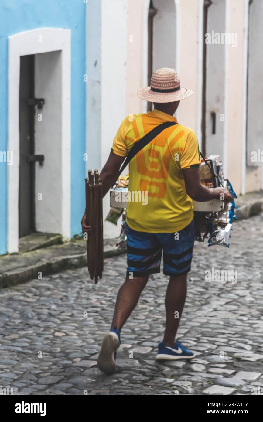 A worker walking down a picturesque cobblestone street in Brazil Stock ...