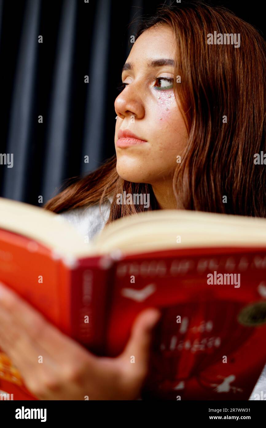 Teenage latin hispanic girl reading a book Stock Photo - Alamy