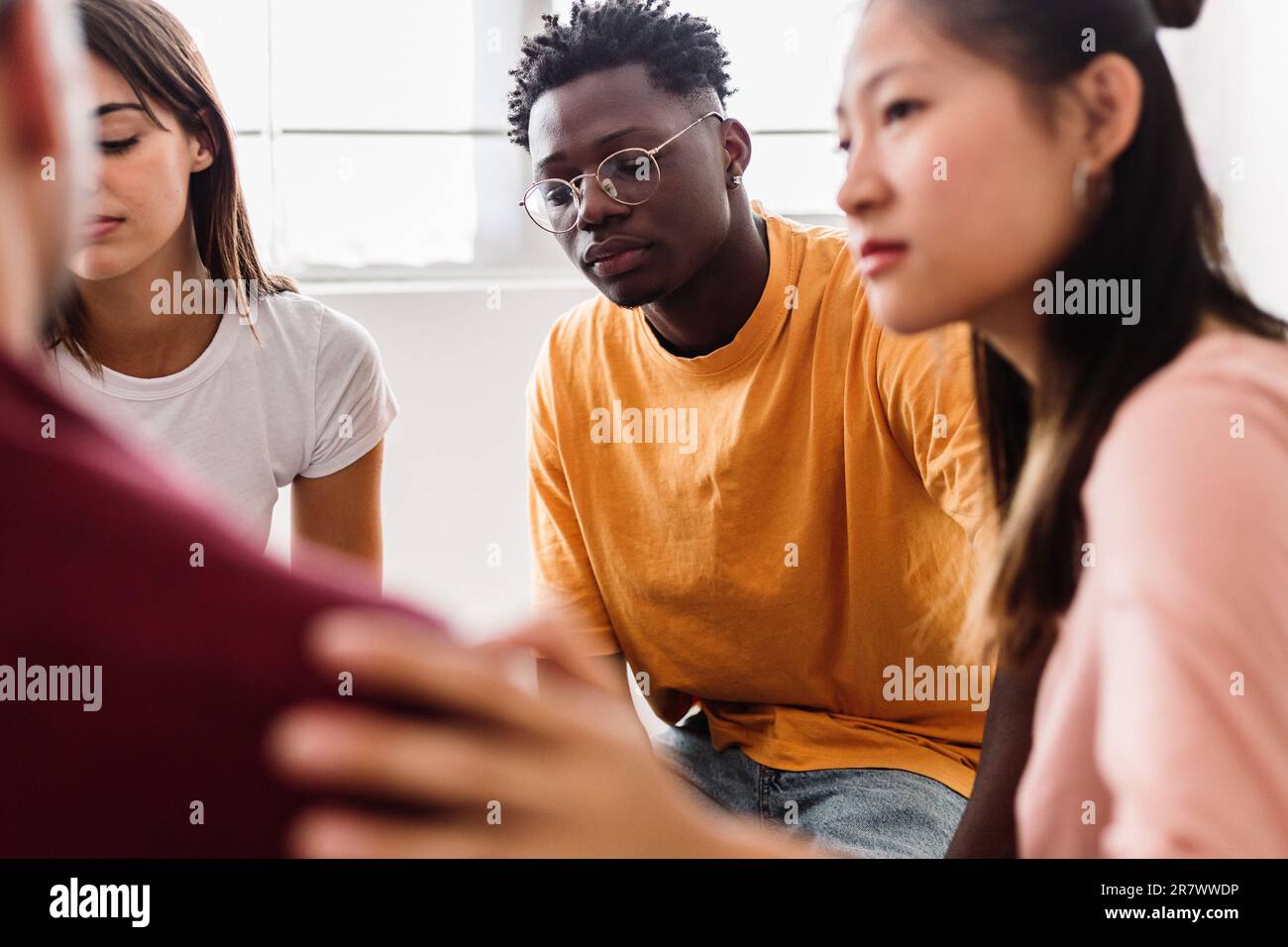 Therapy group people supporting each other talking at community center ...