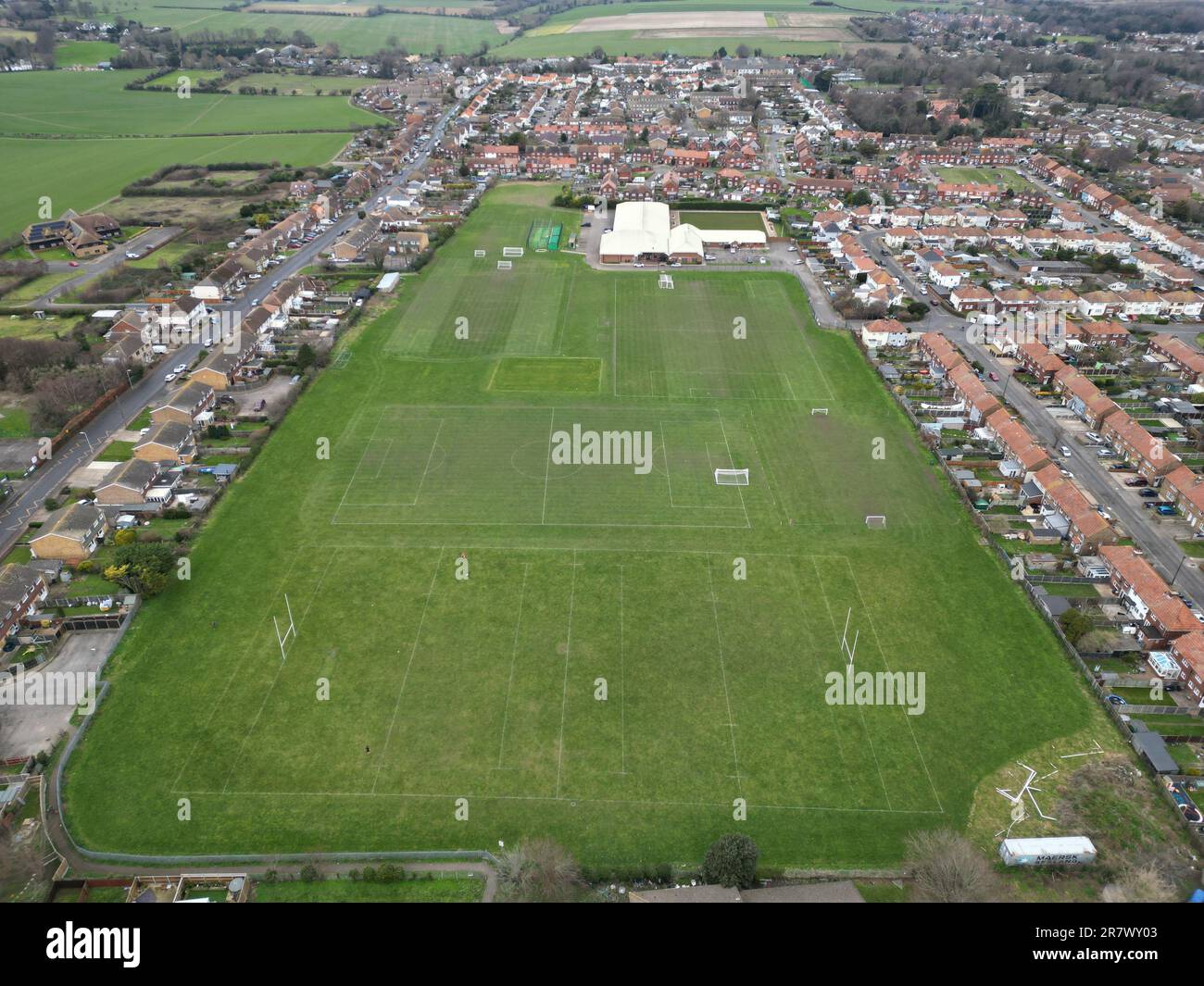 An aerial shot of a football field surrounded by buildings in a ...