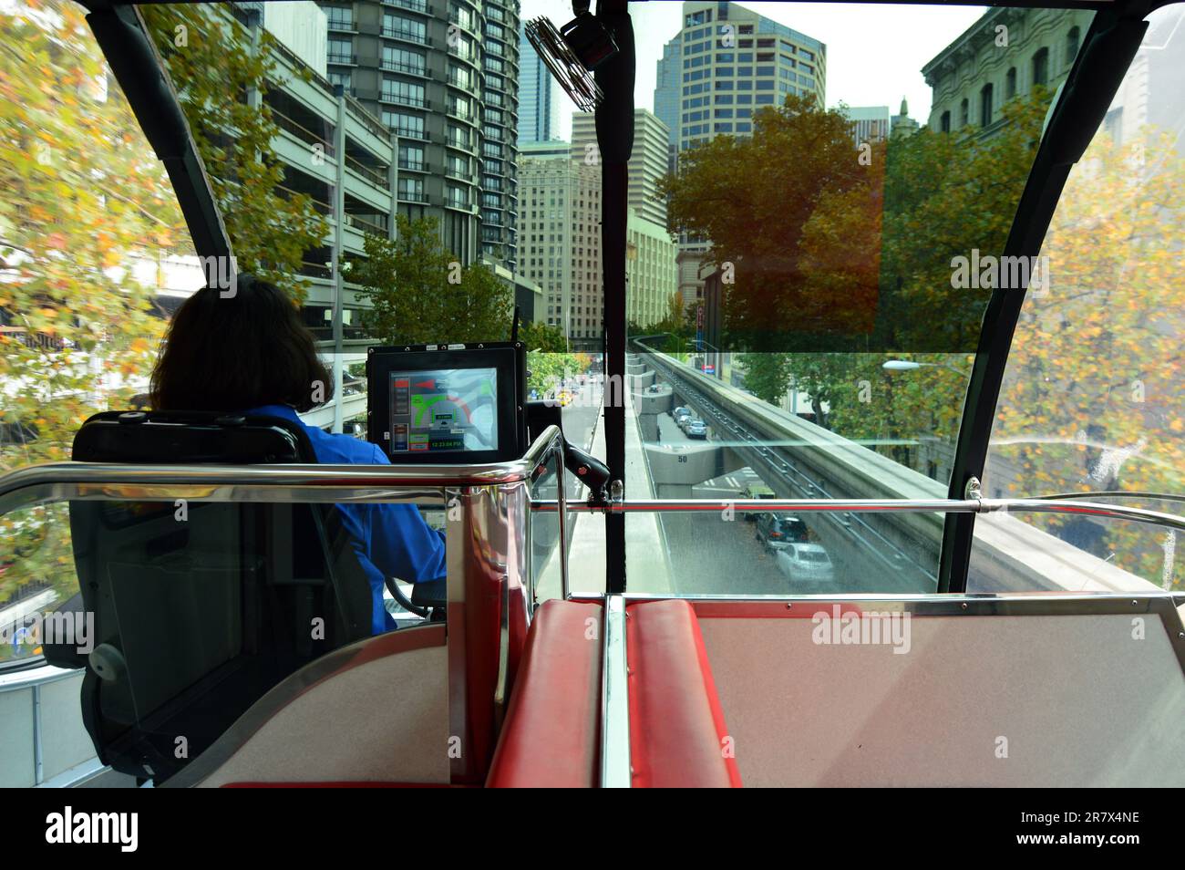 A female conductor drives the monorail through downtown Seattle Stock ...