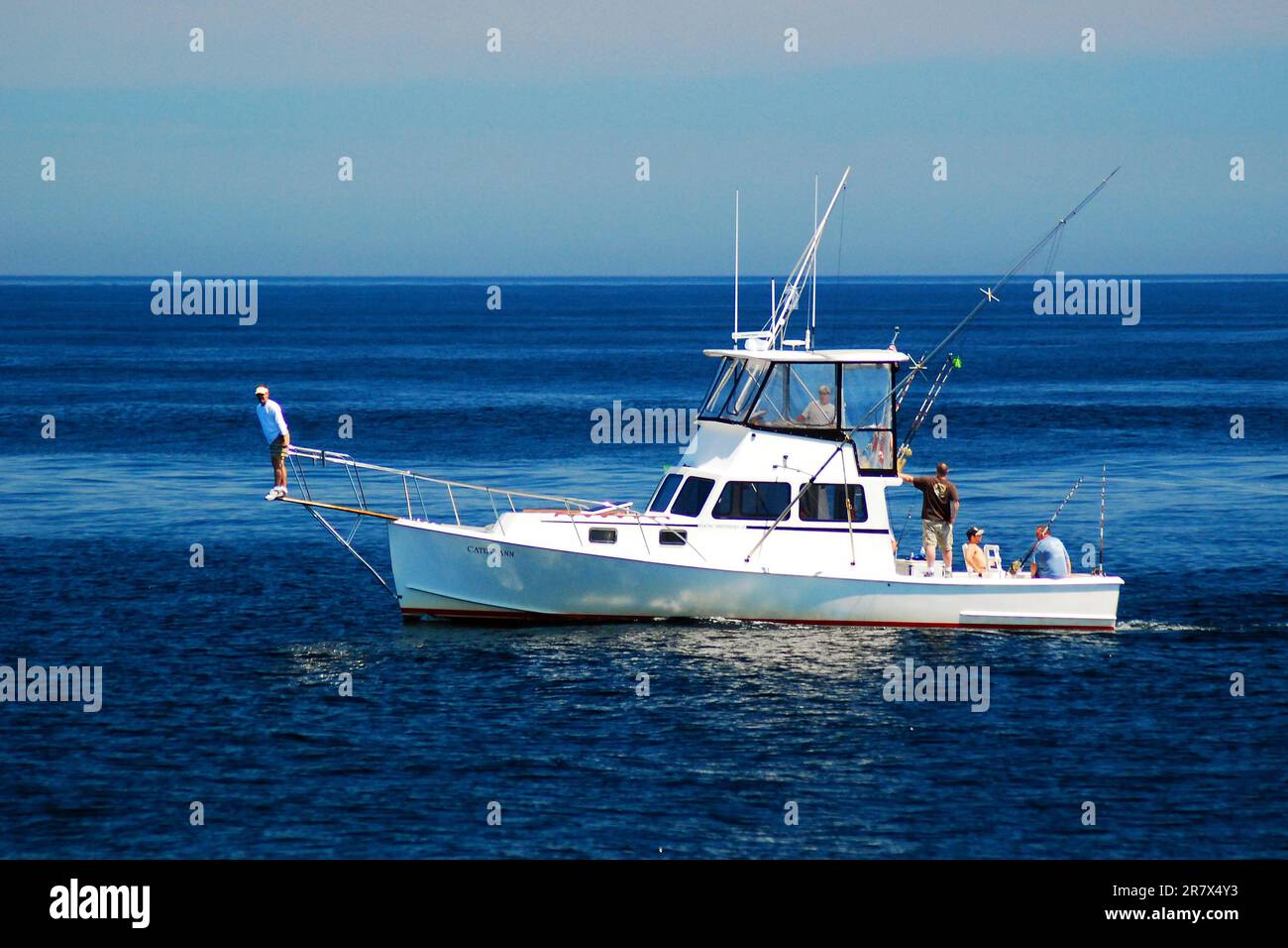 Men enjoy fishing on an unusually calm summer day on the ocean Stock ...