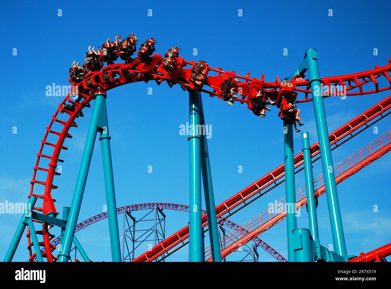 Thrill seekers enjoys the twists and inversions of a wild rollercoaster ...