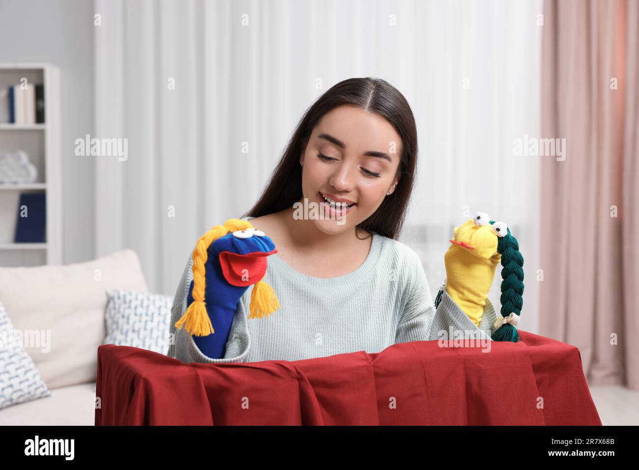 Happy woman performing puppet show at home Stock Photo - Alamy