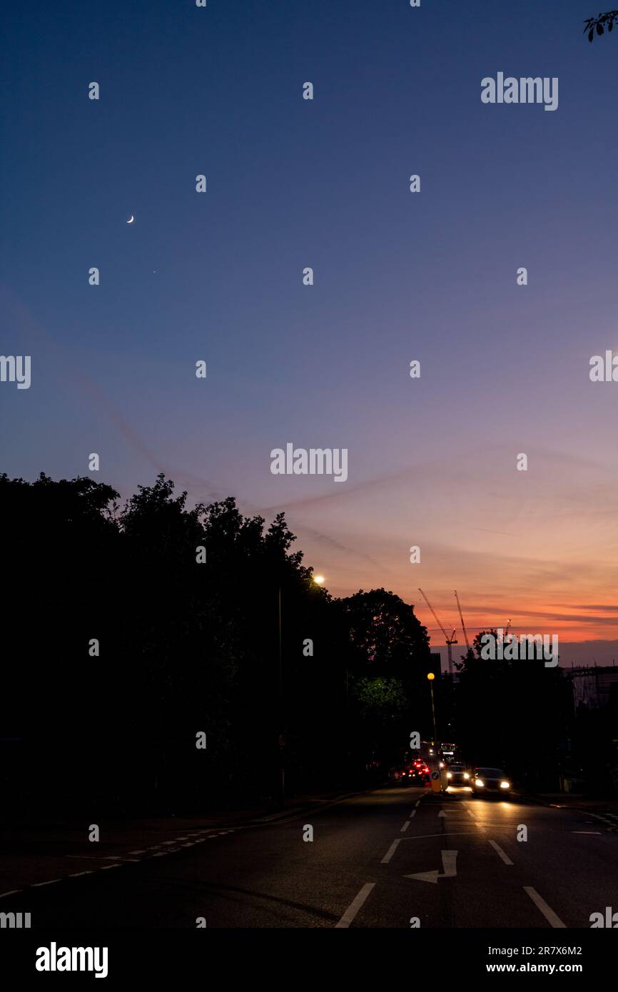 Blue evening sunset. In the sky new Moon and Venus. Dark road Stock ...