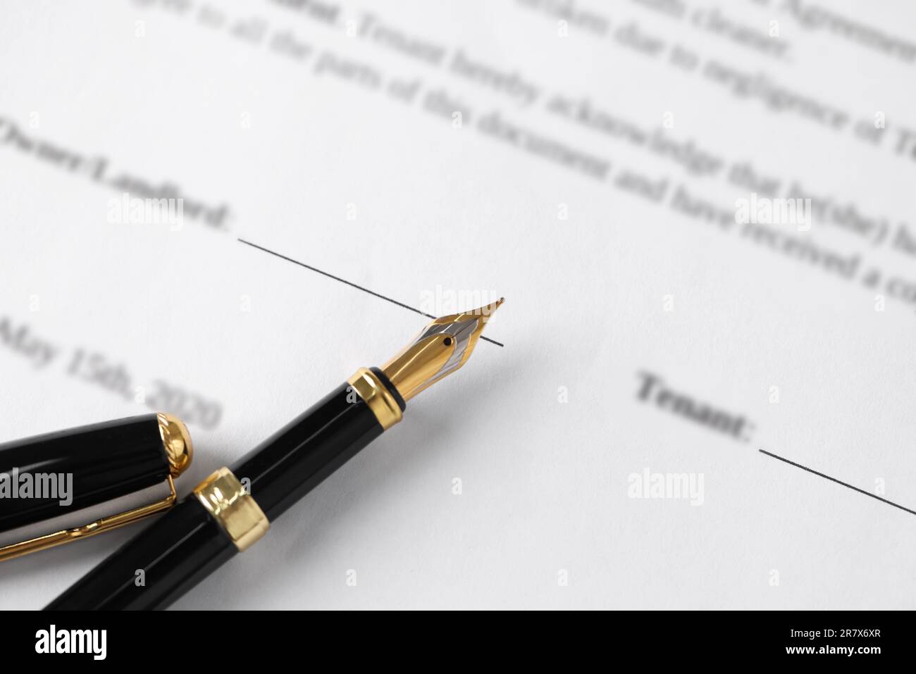 Fountain pen on document with place for signature, top view. Notary ...