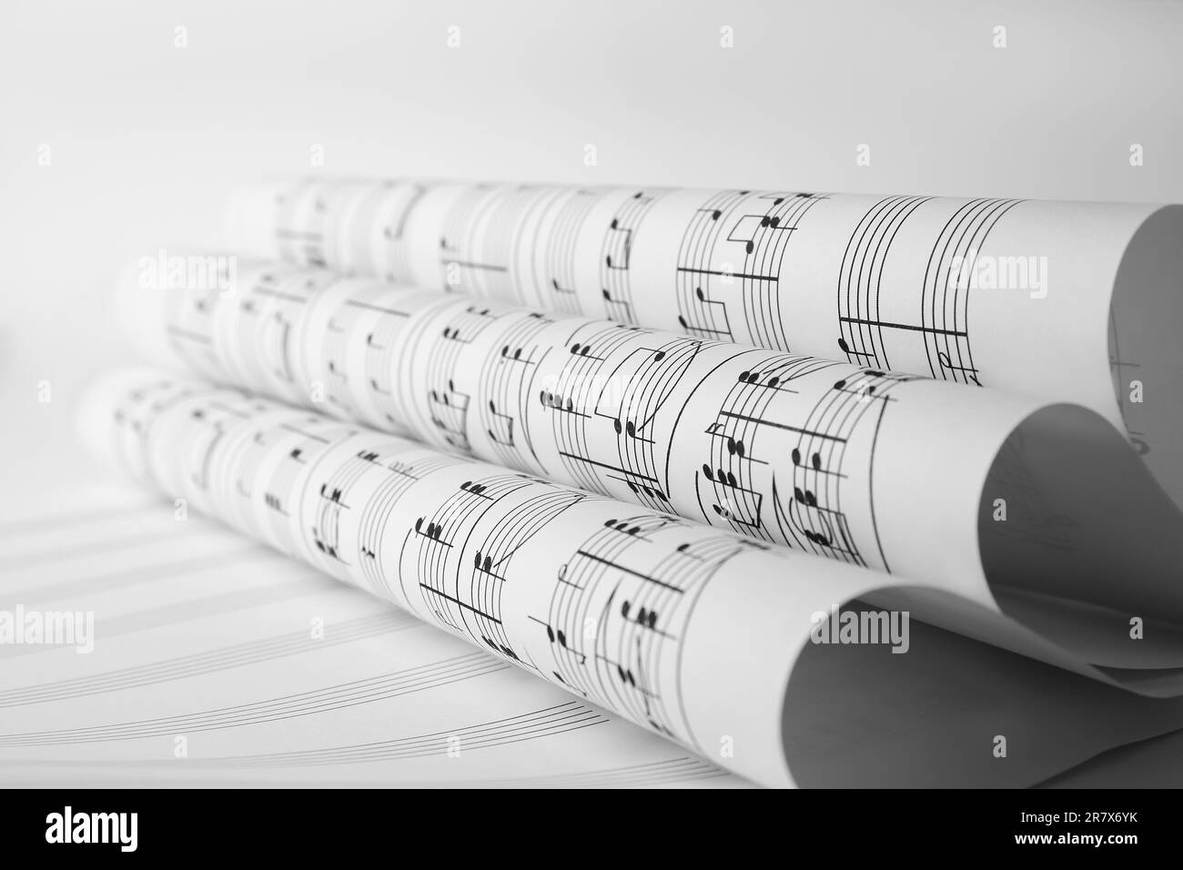 Rolled sheets with music notes on white background, closeup Stock Photo ...