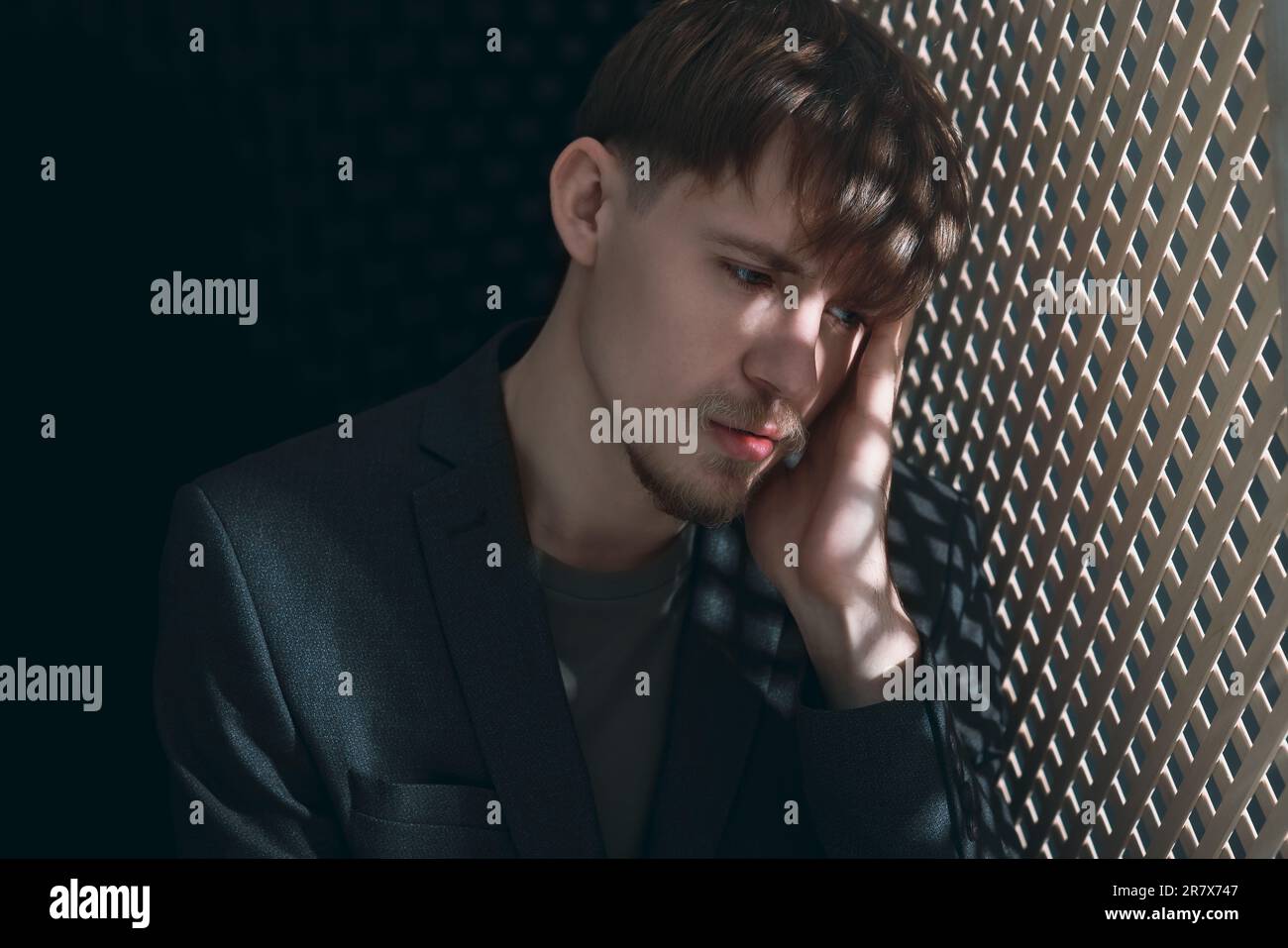 Upset young man during confession in booth Stock Photo - Alamy