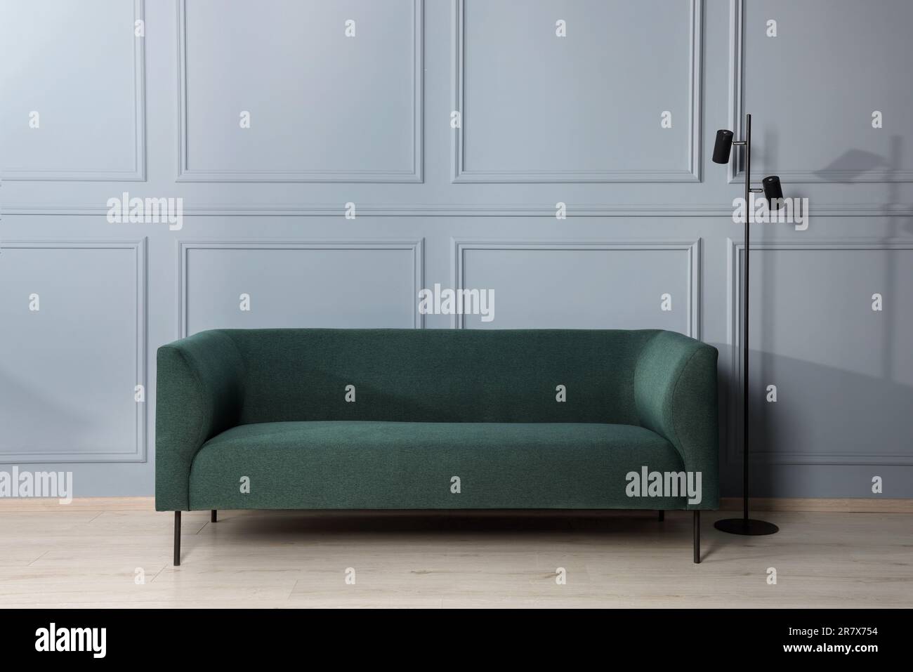 Comfortable sofa and lamp in light room. Interior design Stock Photo ...