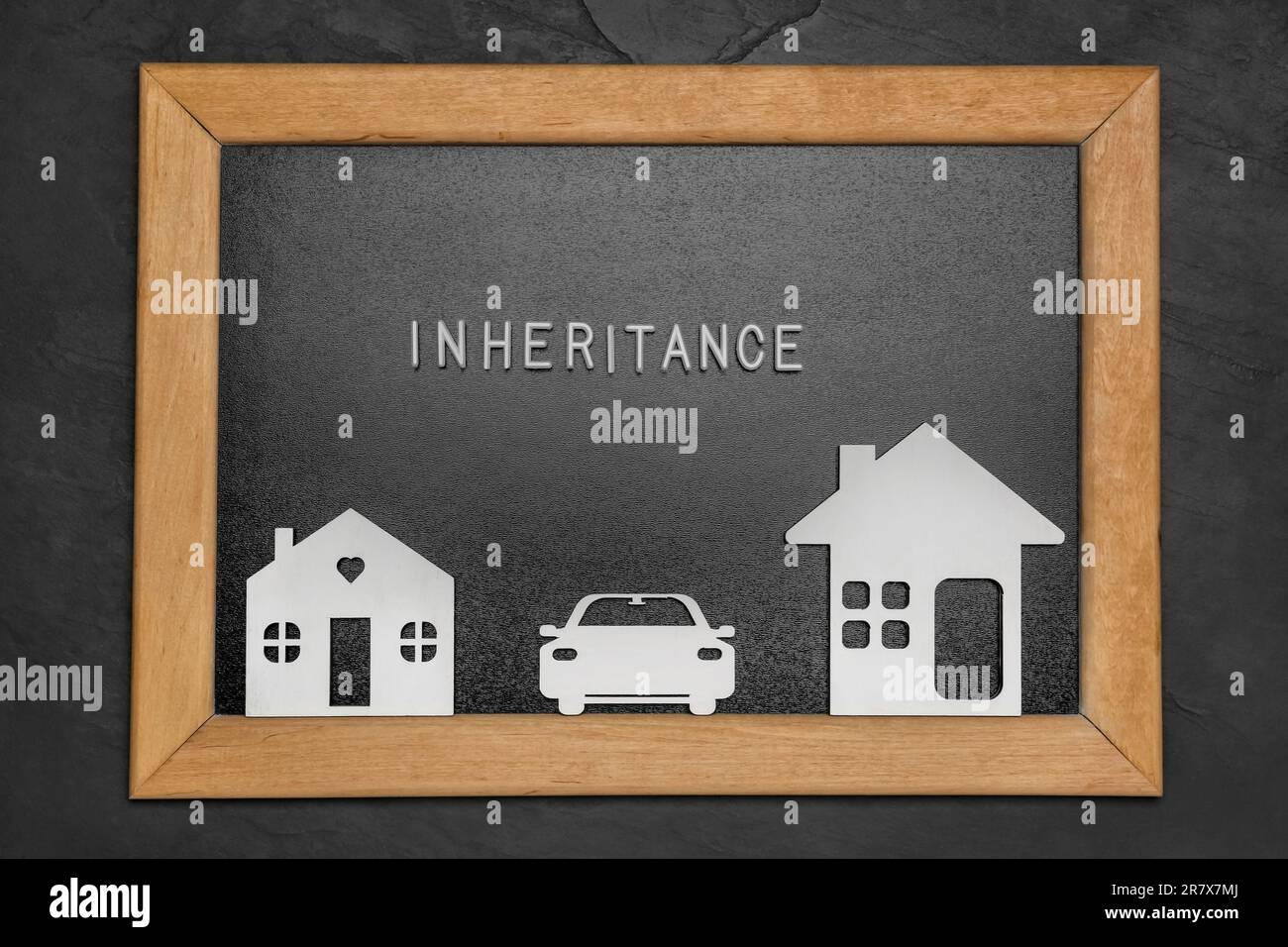 Board with word Inheritance and different cutouts on black background ...