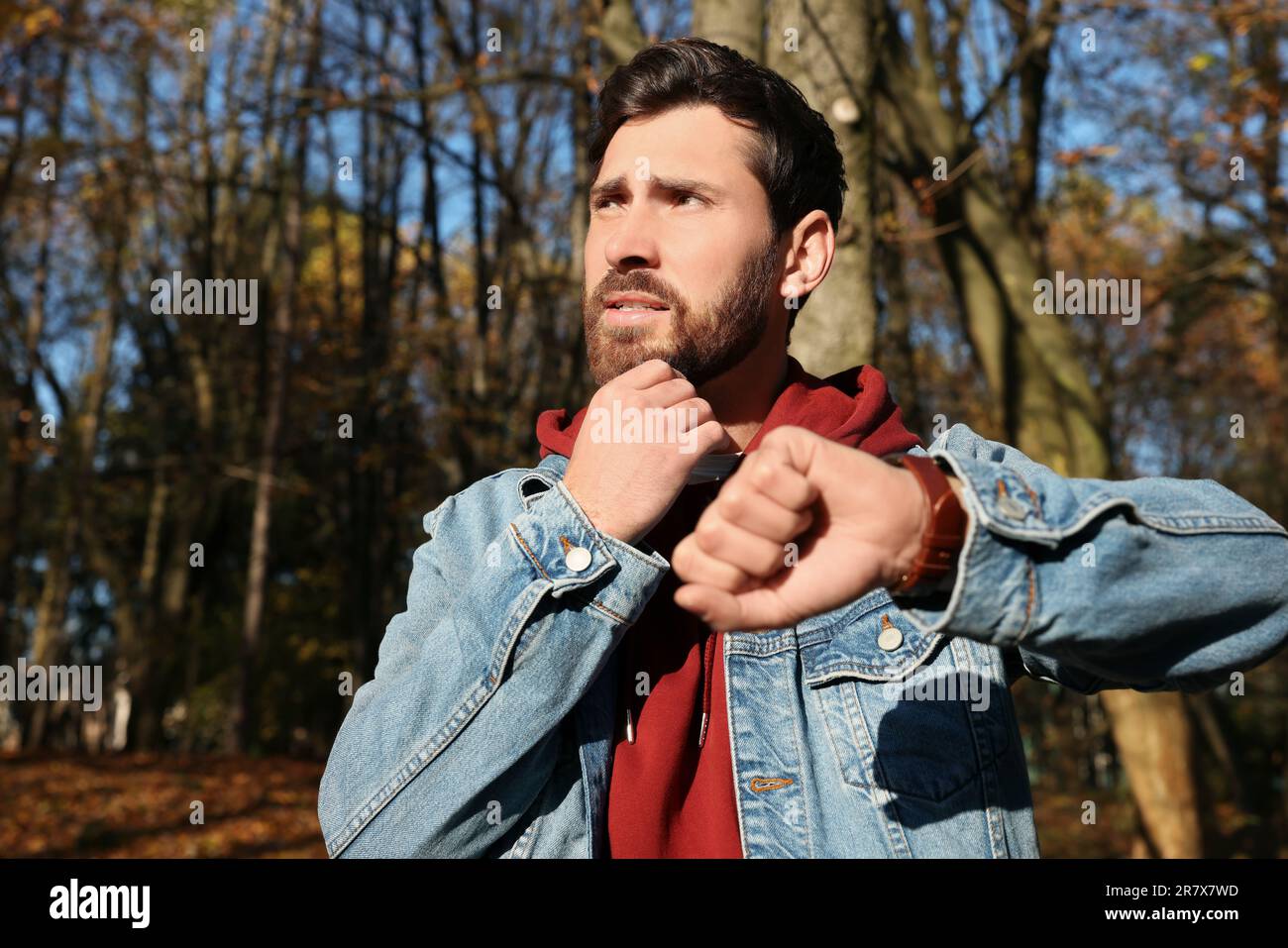 Man checking time on watch in park. Being late concept Stock Photo - Alamy