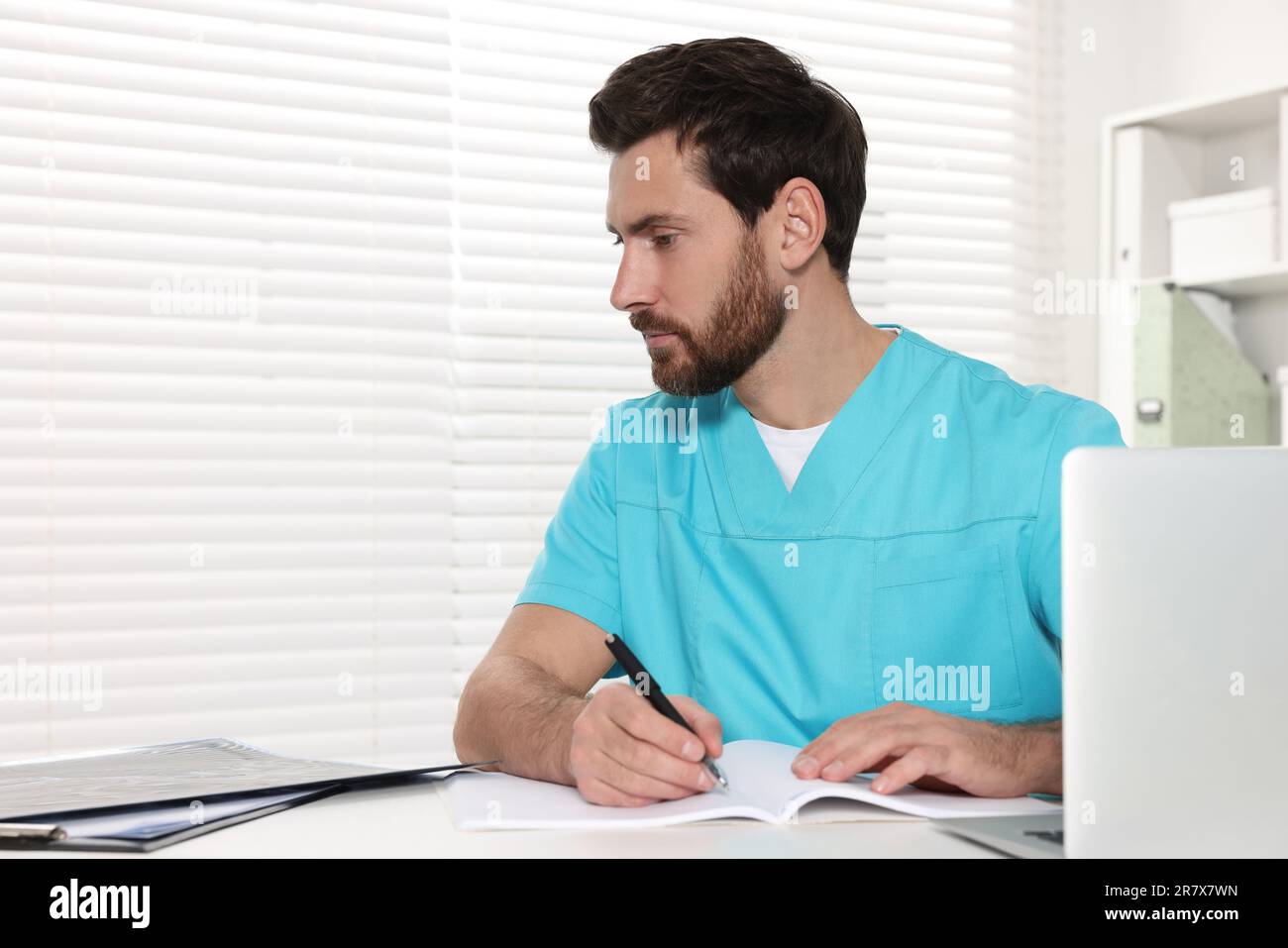 Doctor writing results from MRI scan in hospital Stock Photo - Alamy