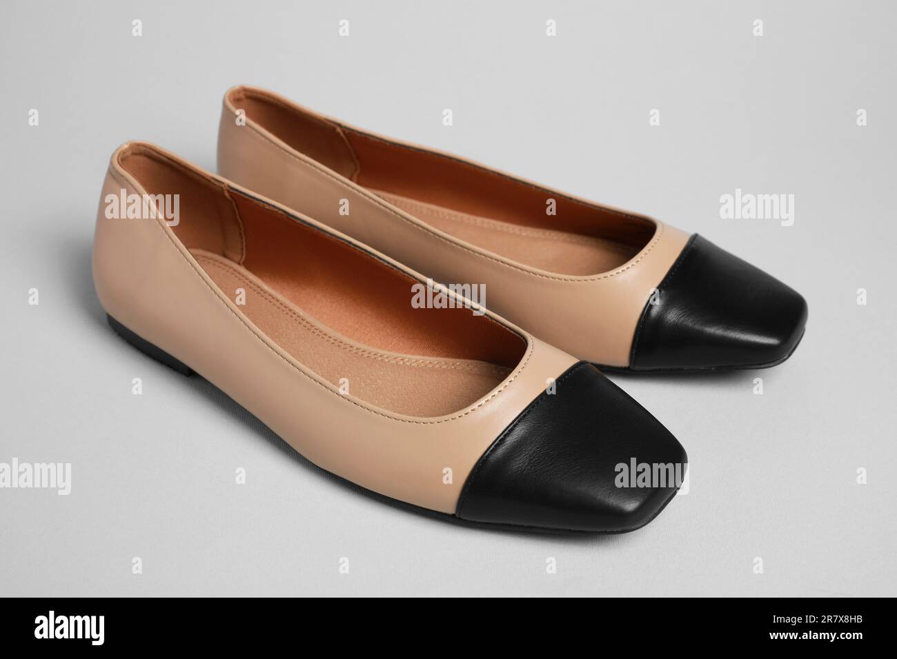Pair of new stylish square toe ballet flats on light grey background ...