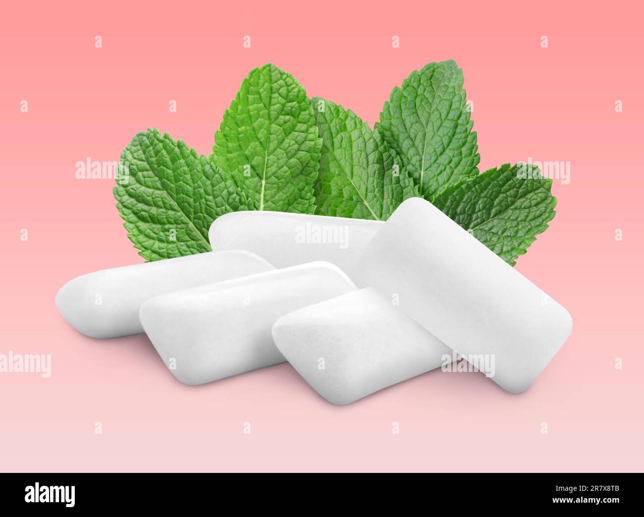 Menthol chewing gum pillows and mint leaves on pink gradient background ...