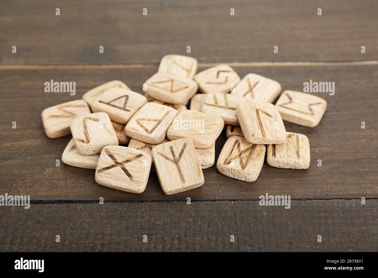 Pile of runes with different symbols on wooden table Stock Photo - Alamy