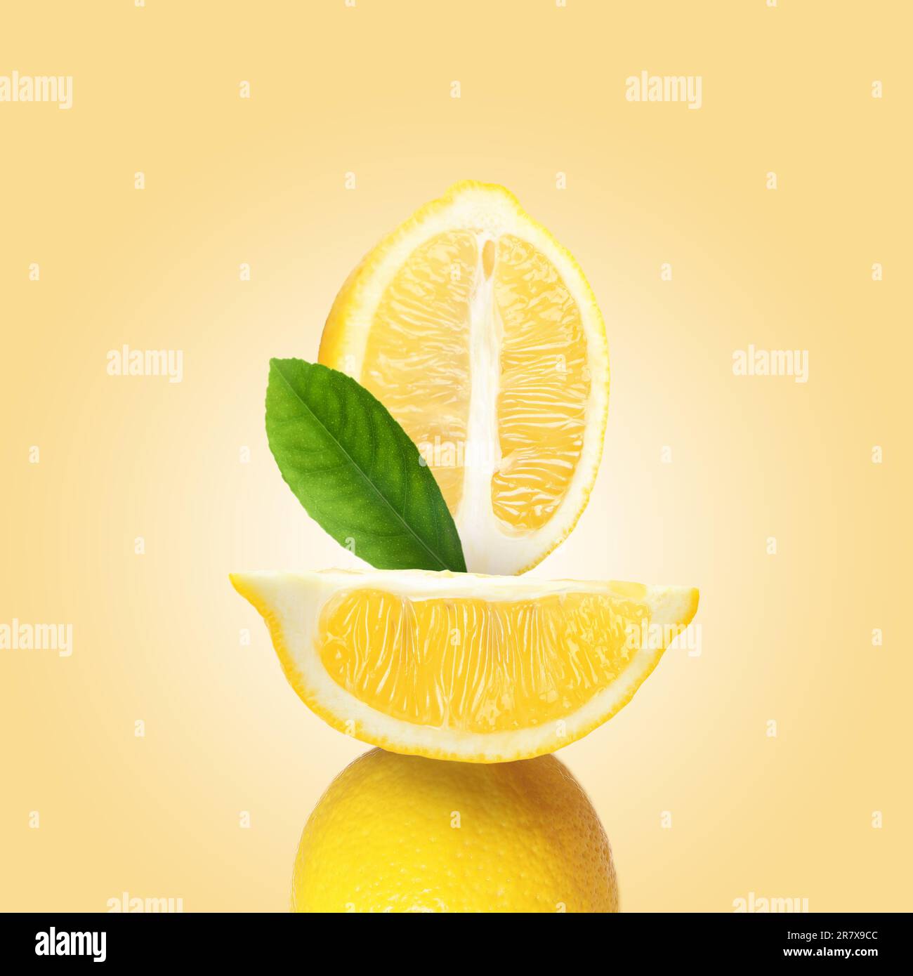Stack of fresh lemons with green leaf on pastel gold background Stock ...