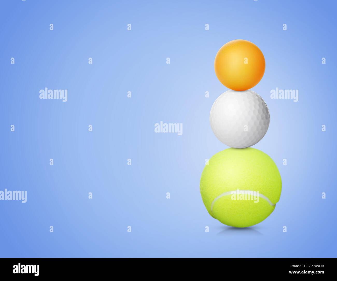 Stack of different sport balls on pale blue background, space for text ...
